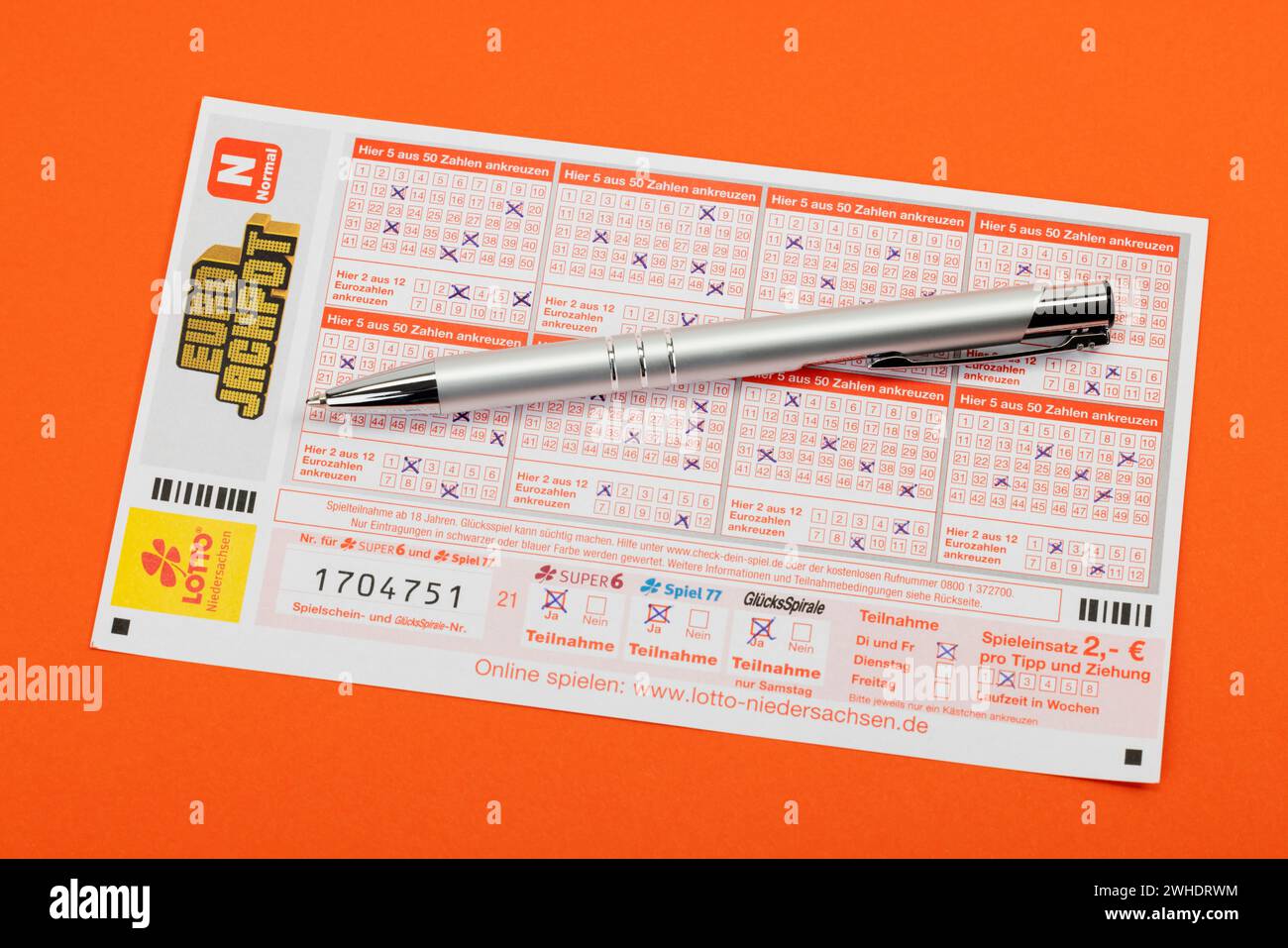 Completed play slip, EUROJACKPOT, ballpoint pen, orange background ...