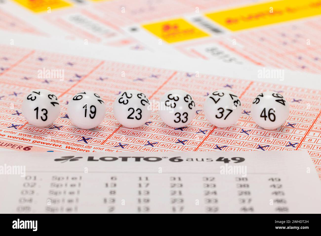 Lotto balls lying on completed lottery ticket hi-res stock photography ...