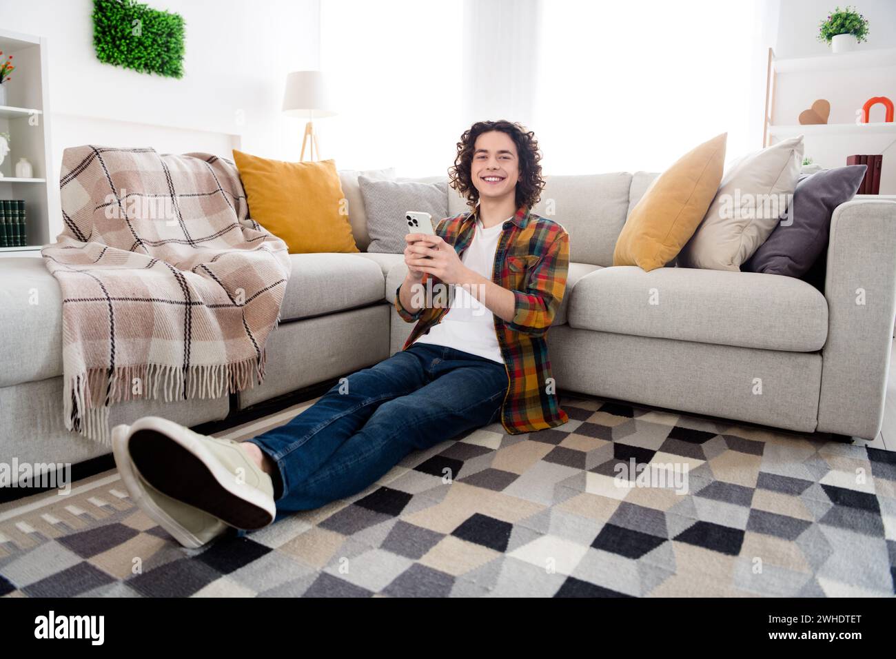 Full length photo of cool good mood guy wear plaid shirt texting sms ...