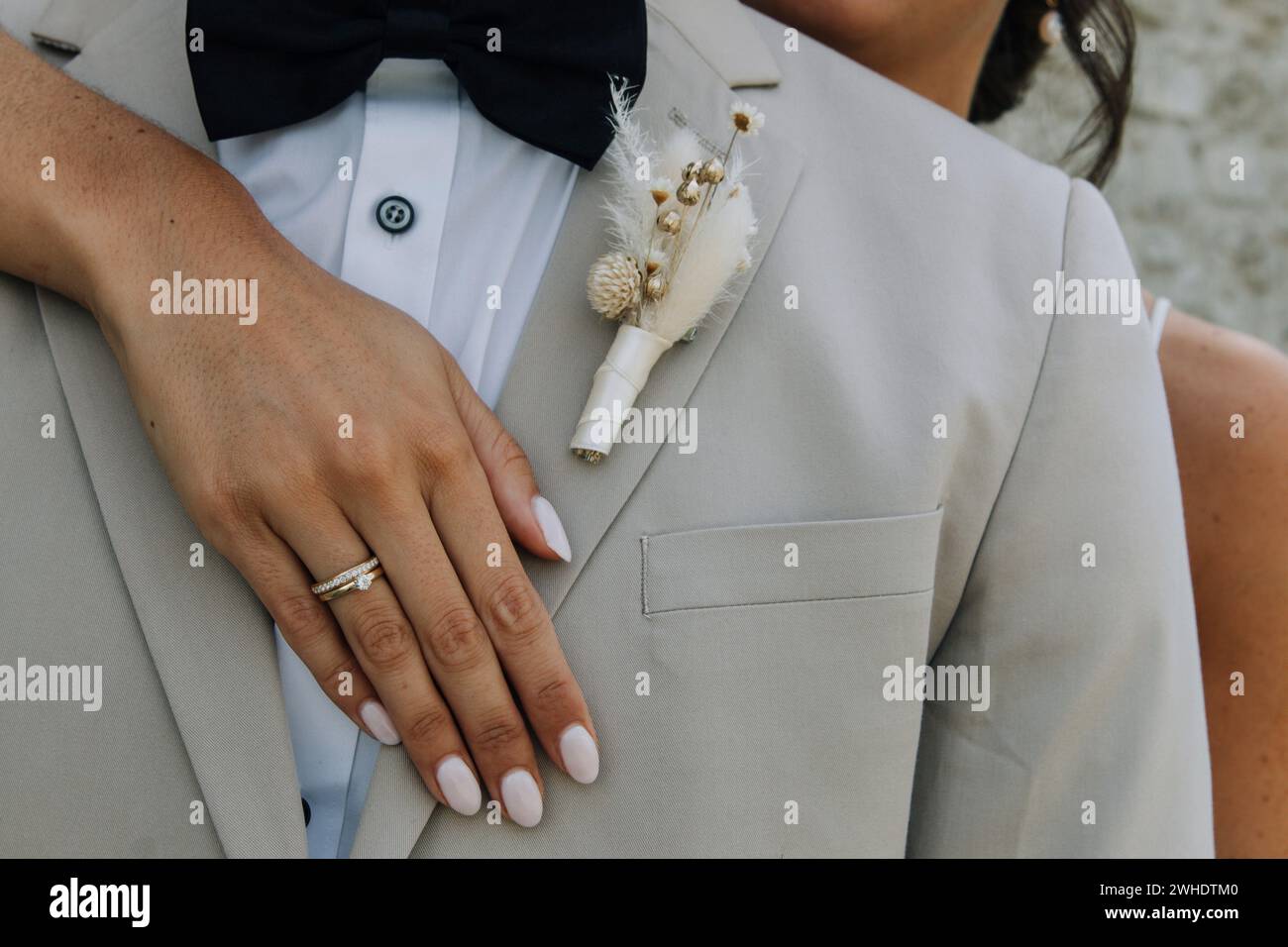 Bride hugs groom, holding hands, wedding rings, hand on heart Stock ...