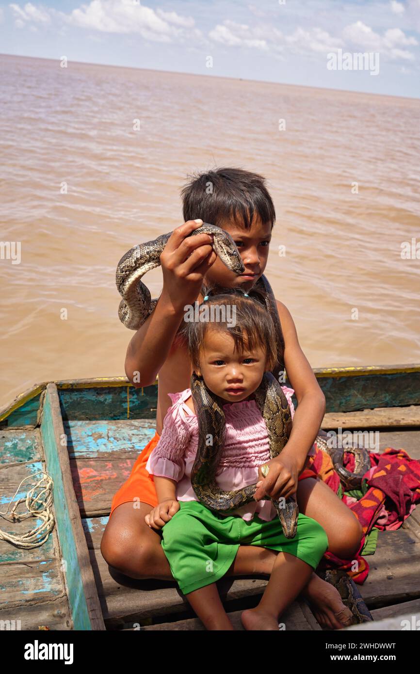 Siem Reap,Camboda,July 6, 2019-A young boy and girl eke out a living ...