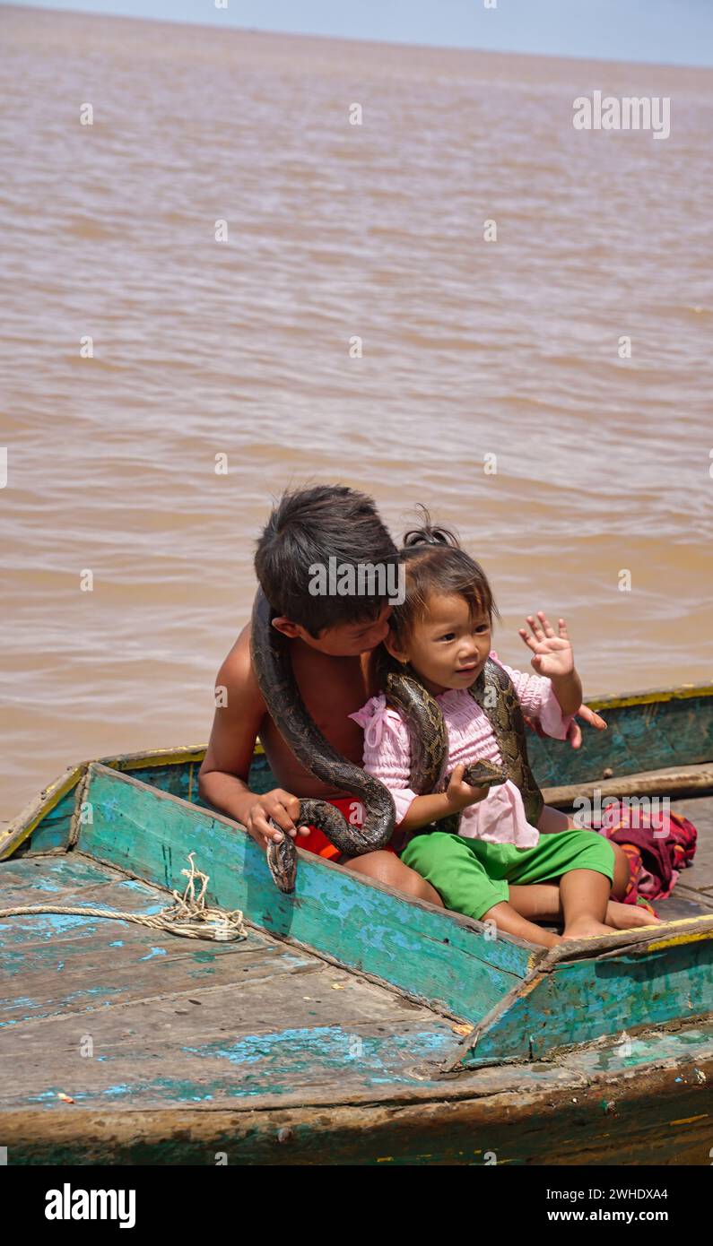 Siem Reap,Camboda,July 6, 2019-A young boy and girl eke out a living ...