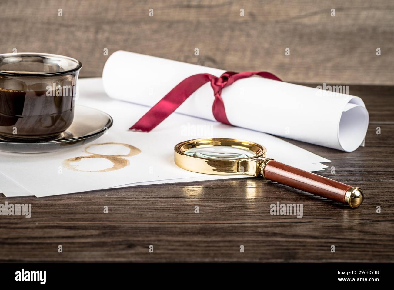 Coffee cup, paper sheets and detective magnifying glass Stock Photo - Alamy