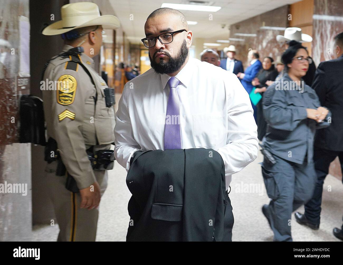 Victor Godinez enters the courtroom handcuffed underneath his coat as ...