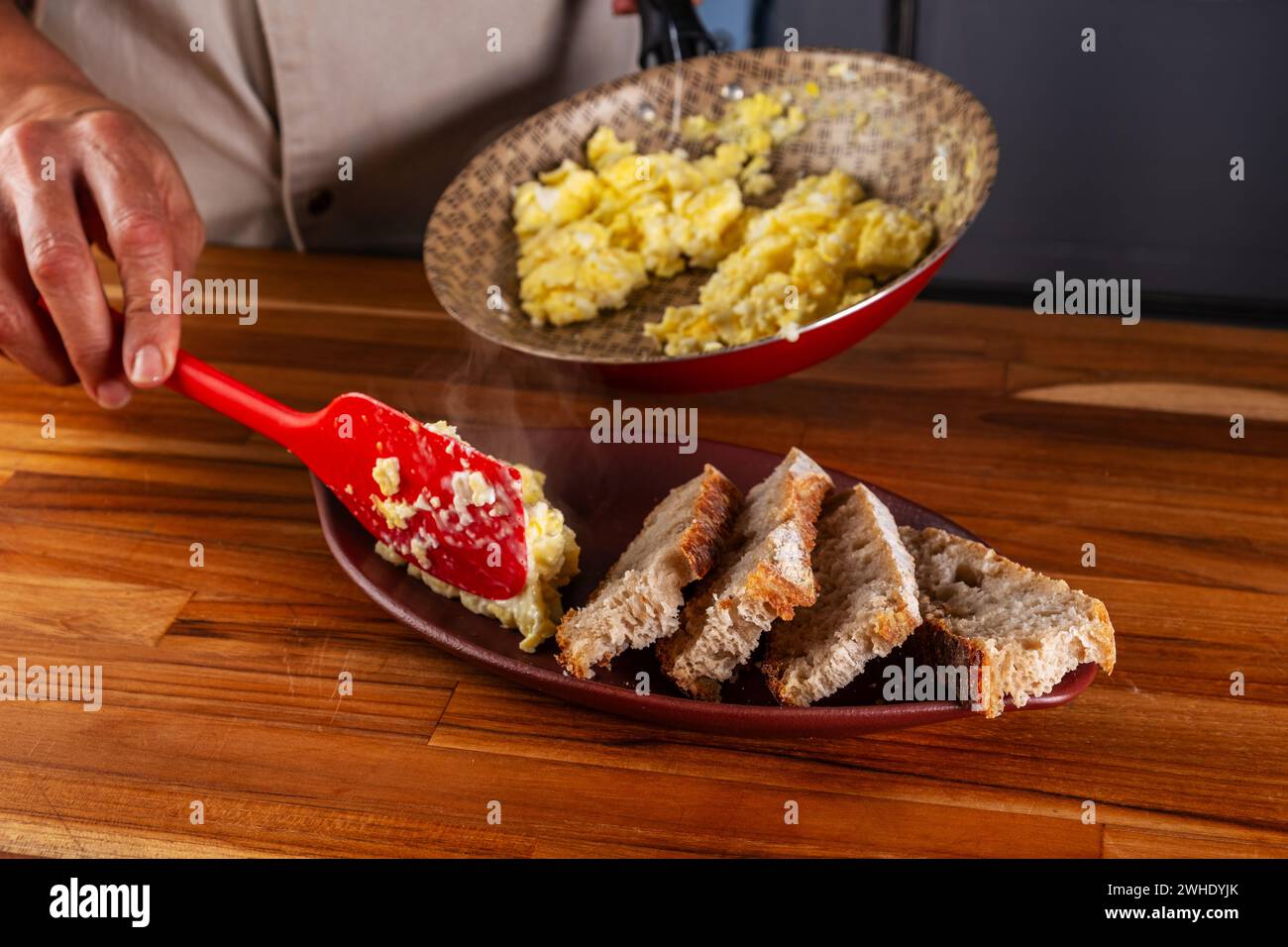 scrambled eggs and slices of artisan bread Stock Photo - Alamy