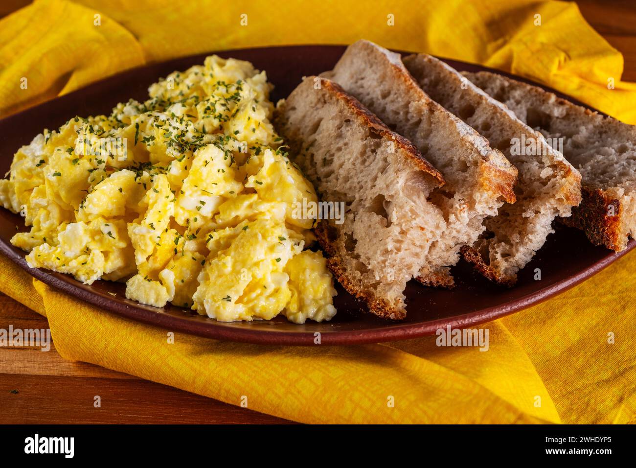 scrambled eggs and slices of artisan bread Stock Photo - Alamy
