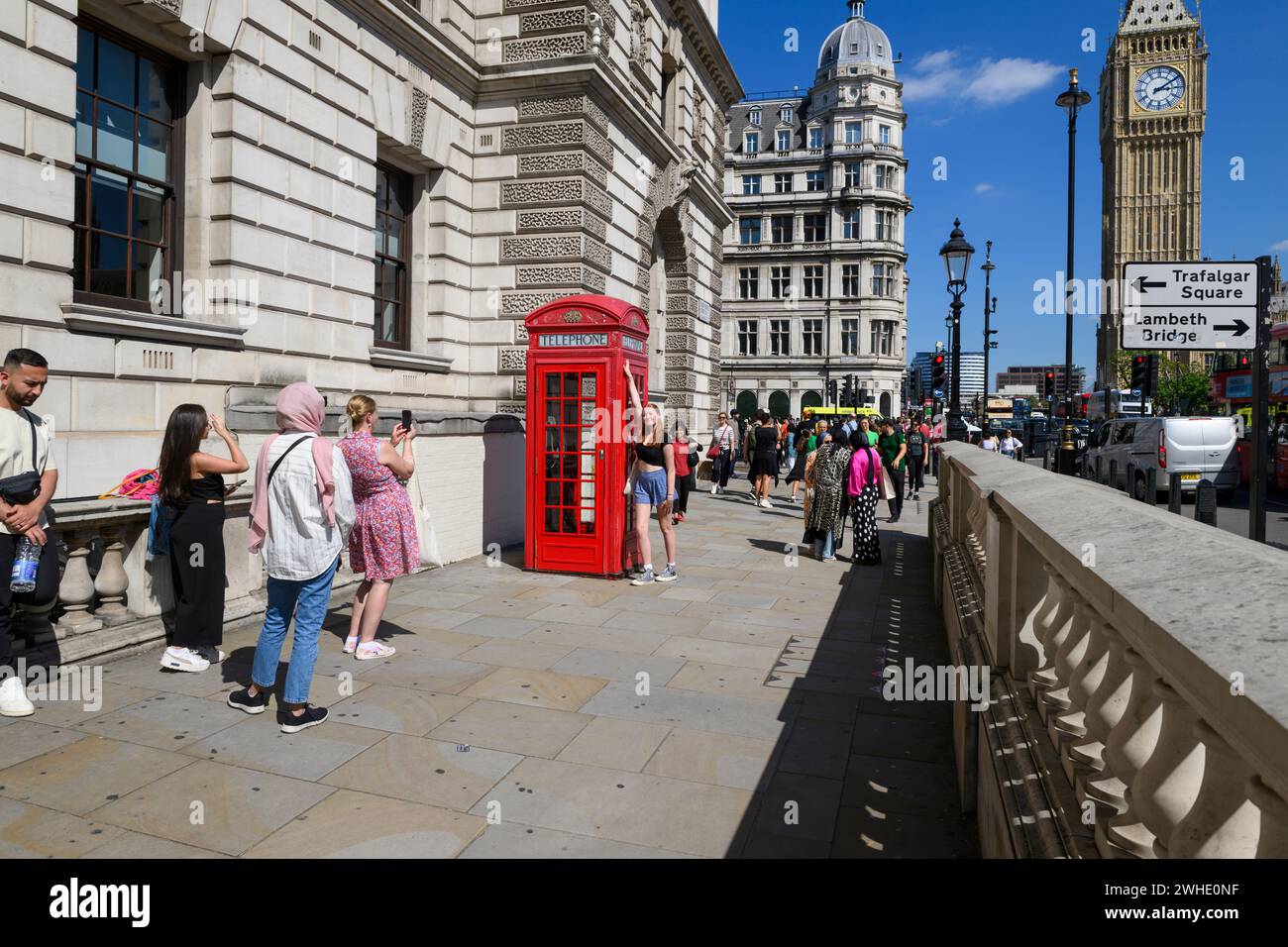 Tourists queuing to take a photo with the iconic K2 red phone box, with ...