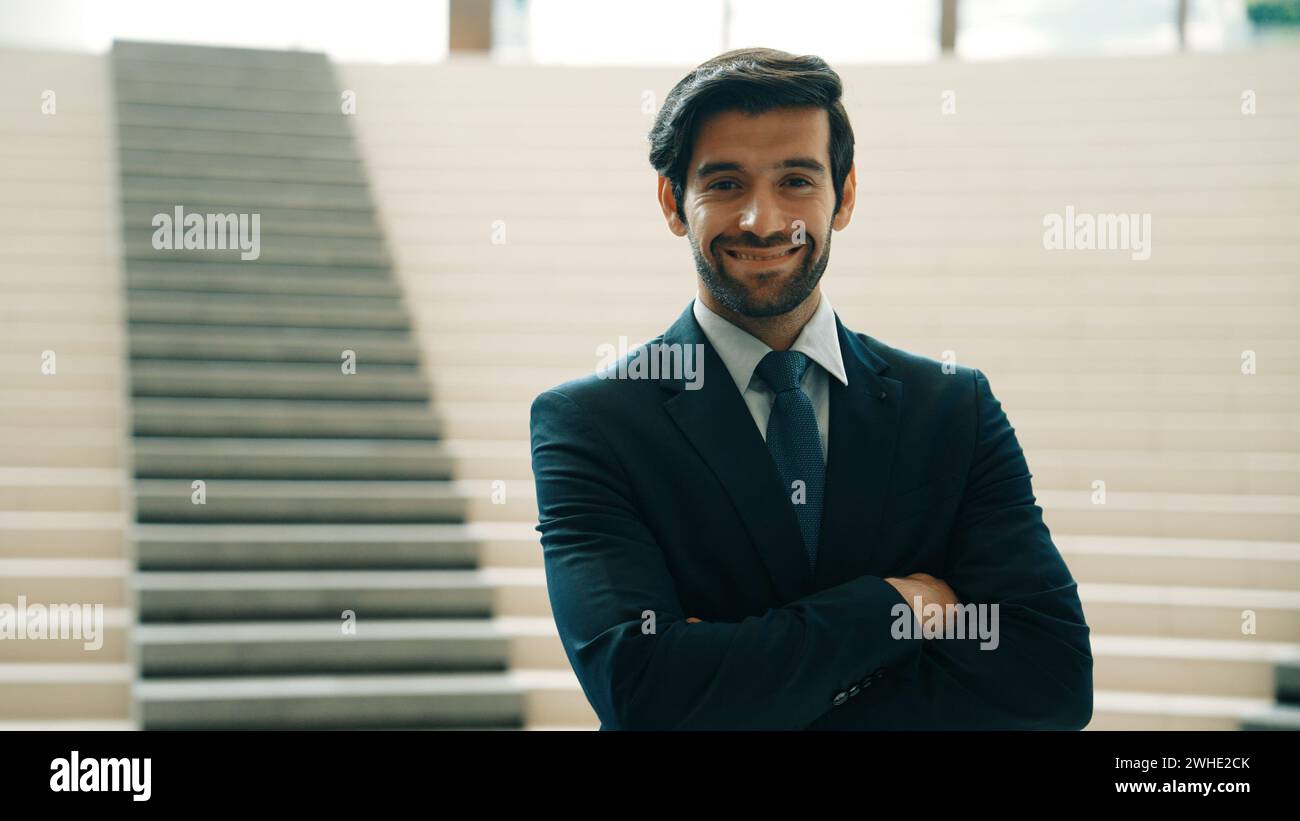 Smart caucasian business man standing with folded arm while looking at ...