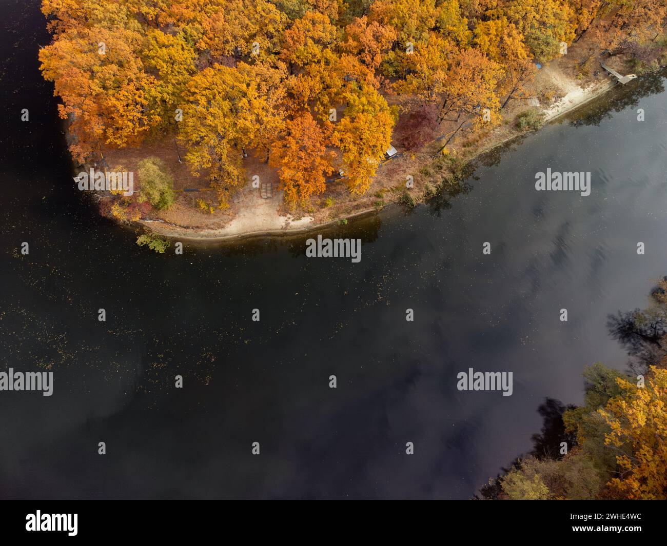 Aerial look down view on river with colorful autumn trees on riverbanks ...