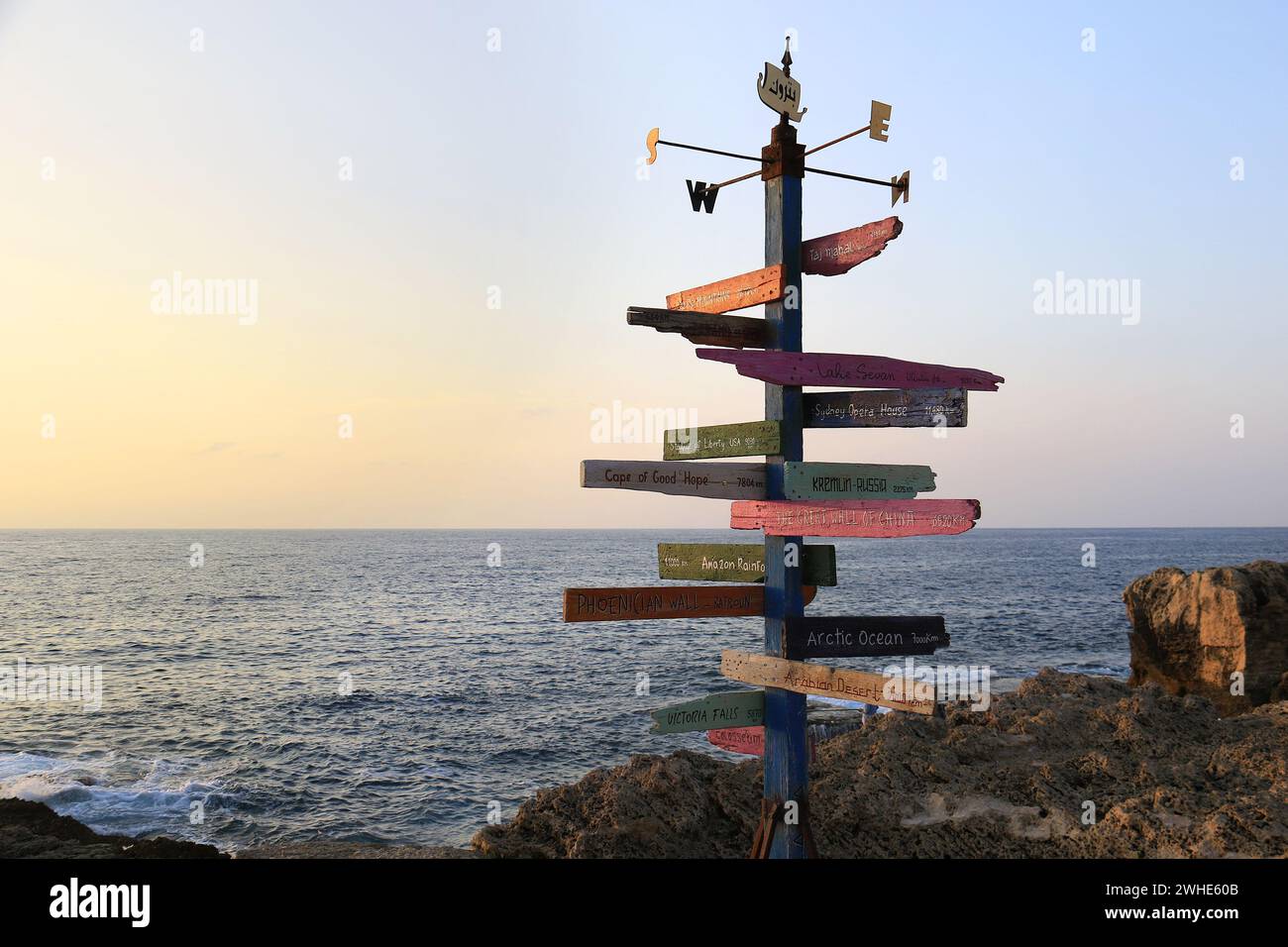 A pole with comical directions planks to various destinations Stock ...