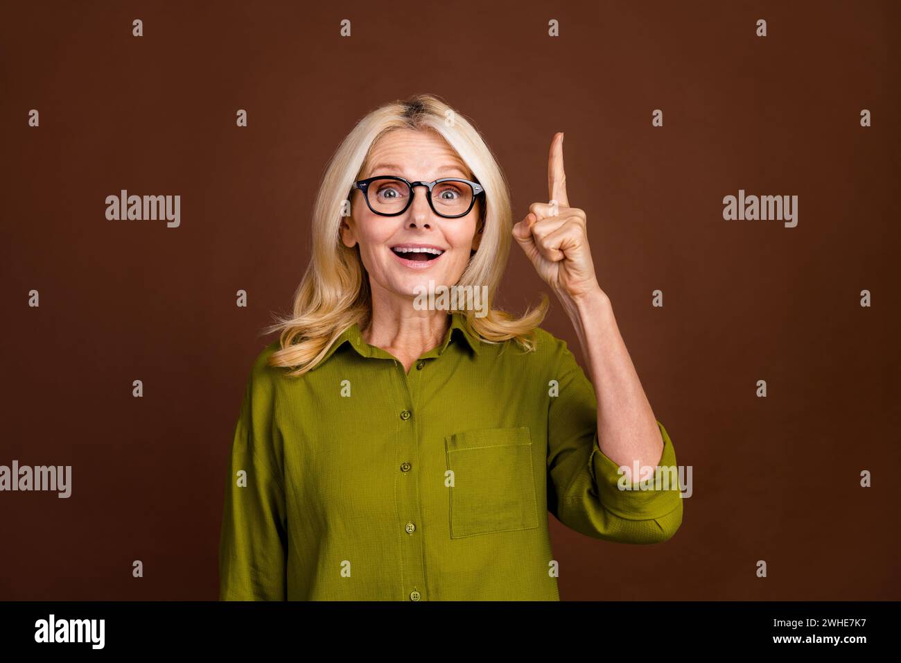 Portrait of smart impressed person wear khaki outfit in eyewear raising ...