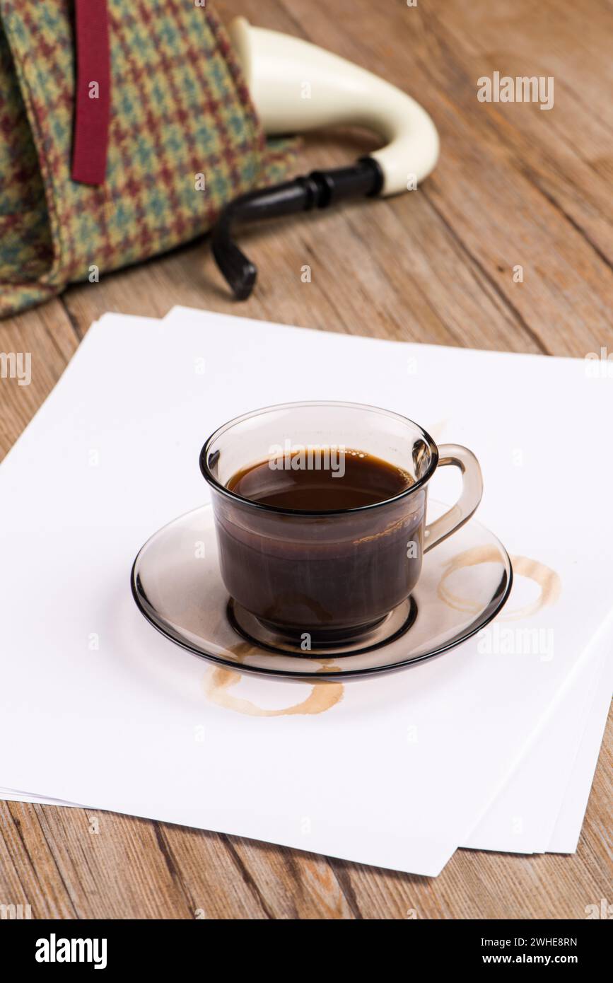 Coffee cup, paper sheets and detective hat Stock Photo - Alamy