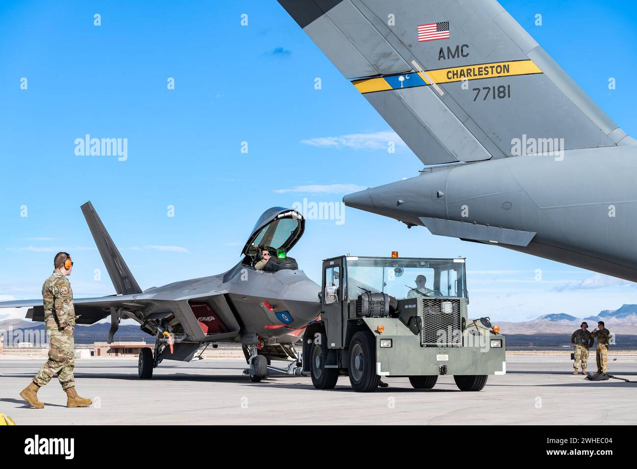An MB4 tow tractor pulls an F-22 Raptor assigned to Elmendorf Air Force ...