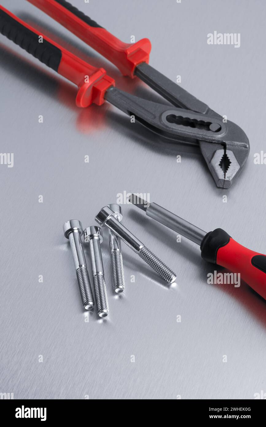 Spanner tool and screws Stock Photo - Alamy