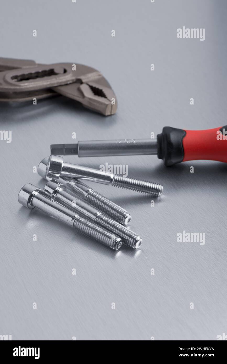 Spanner tool and screws Stock Photo - Alamy