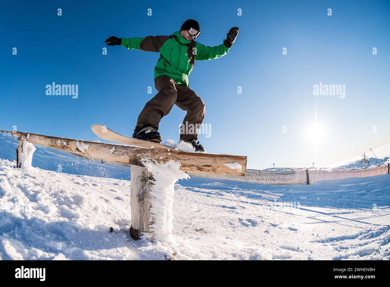 Snowboarder sliding on a rail Stock Photo - Alamy