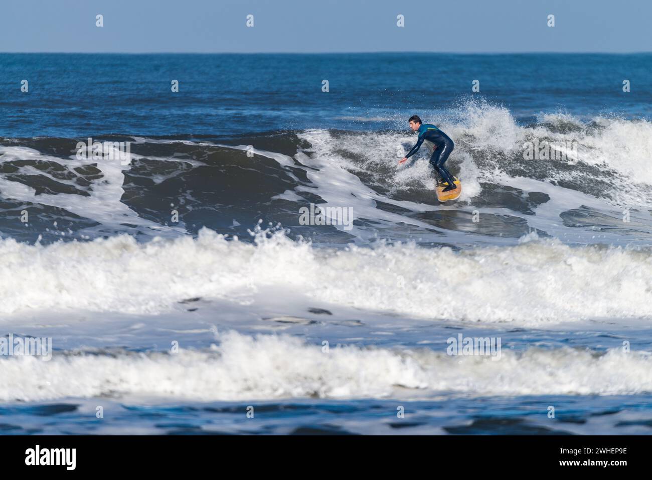 Surfing the waves Stock Photo - Alamy