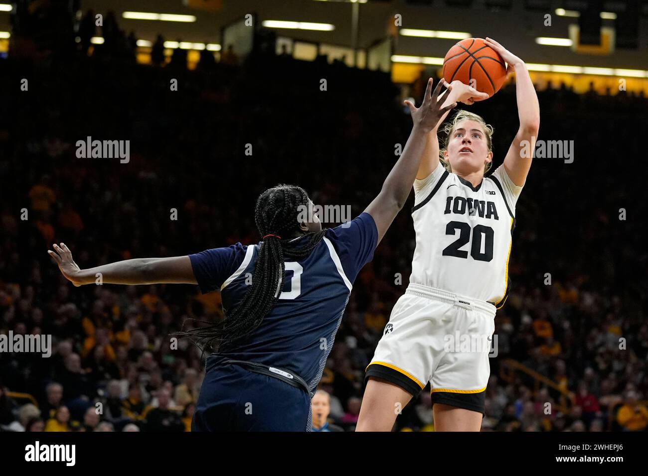 Iowa guard Kate Martin (20) shoots over Penn State guard Ashley Owusu ...