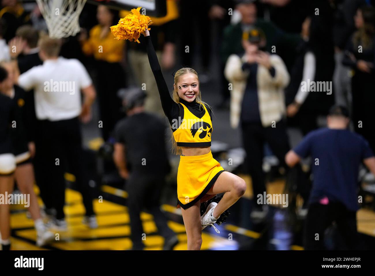 An Iowa cheerleader performs before an NCAA college basketball game ...