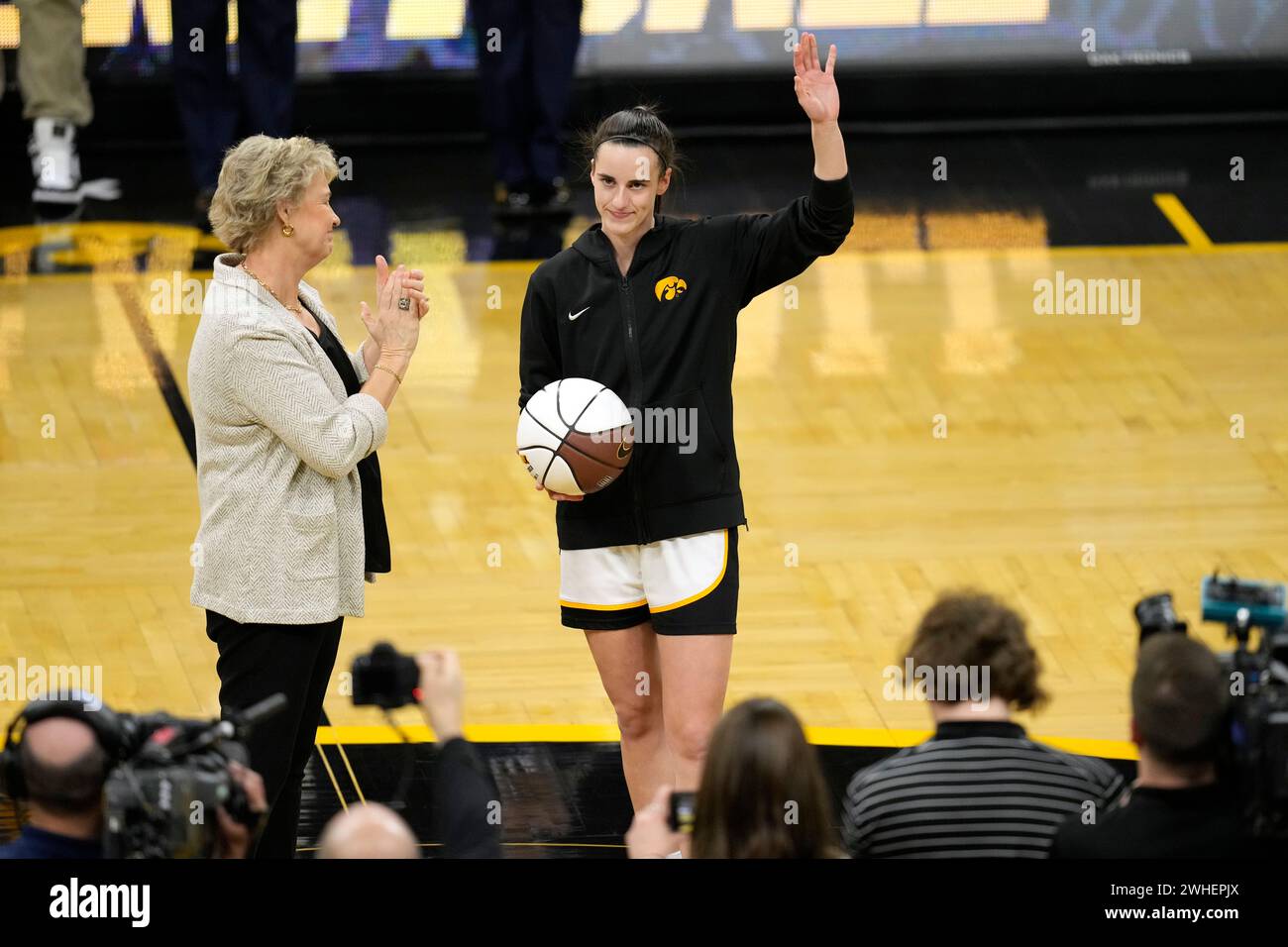 Iowa head coach Lisa Bluder, left, stands with guard Caitlin Clark ...