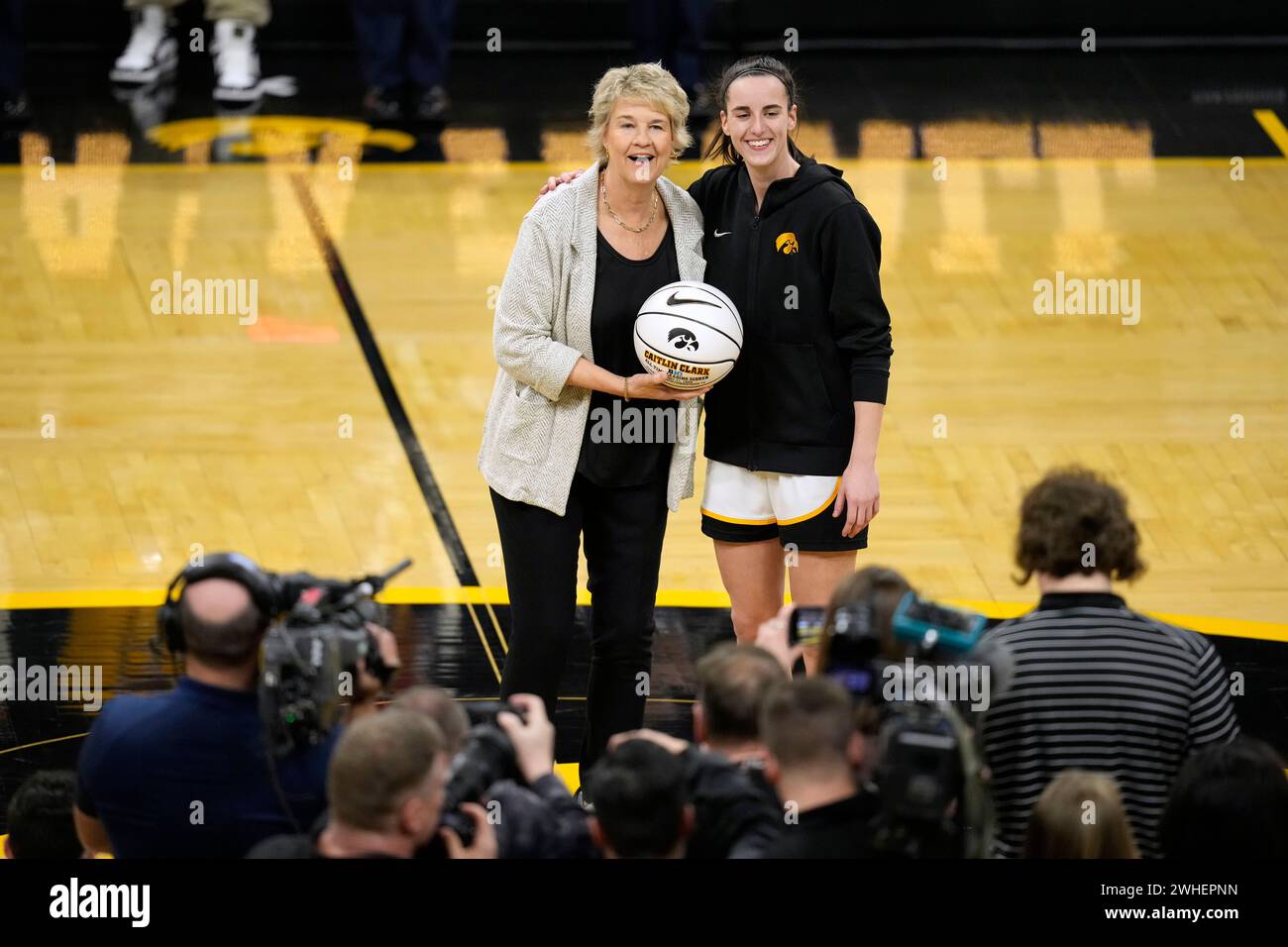 Iowa head coach Lisa Bluder, left, stands with guard Caitlin Clark ...