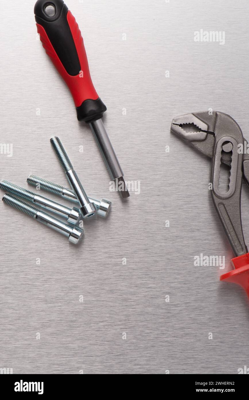 Spanner tool and screws Stock Photo - Alamy