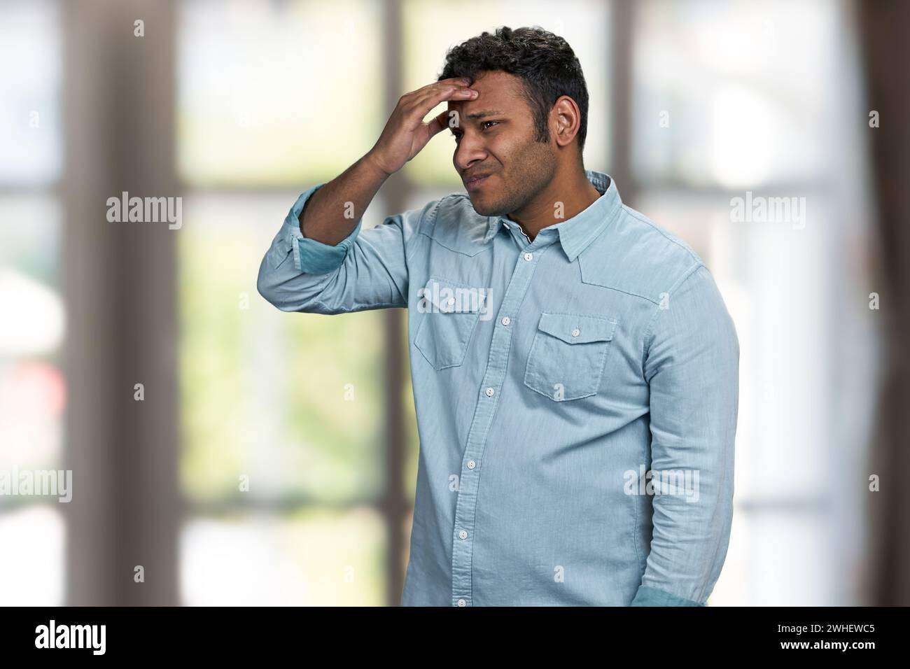 Upset frustrated young man suffering from strong headache. Health ...