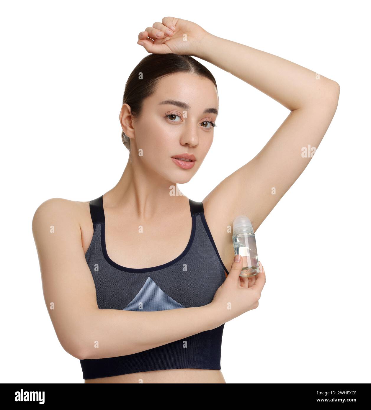 Beautiful woman applying deodorant on white background Stock Photo - Alamy
