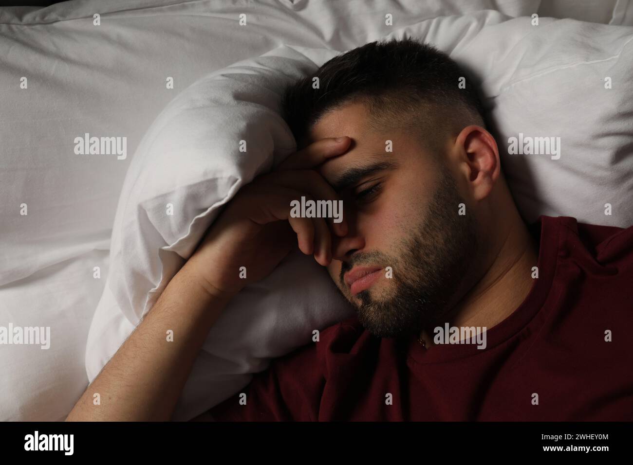 Sad man lying on bed at home, top view Stock Photo - Alamy
