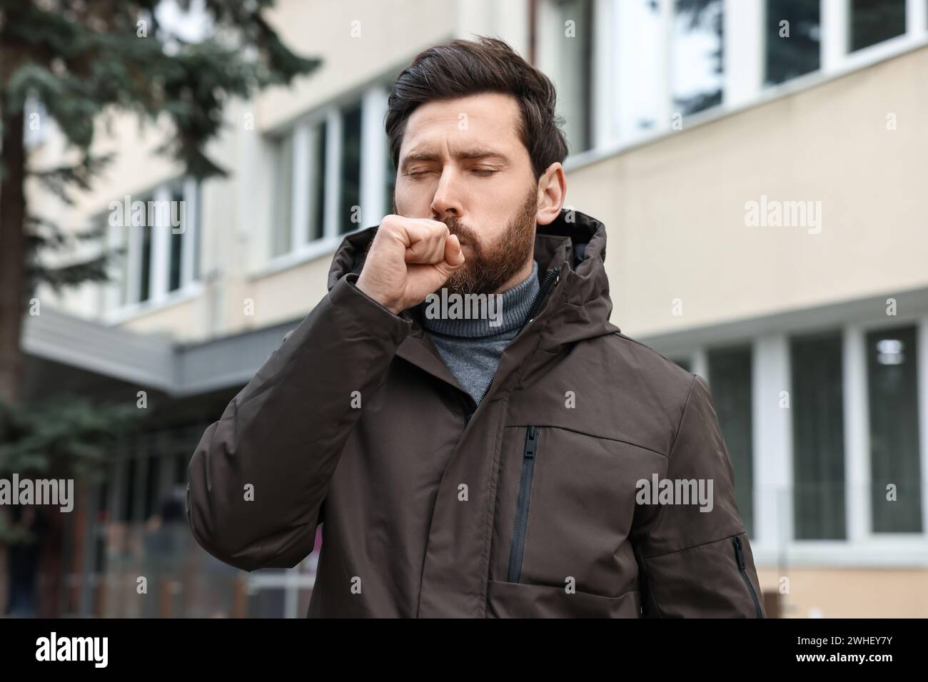 Sick man coughing on city street. Cold symptoms Stock Photo - Alamy