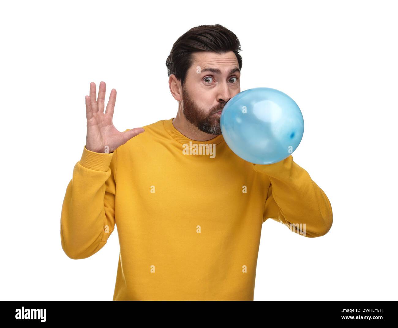 Man inflating light blue balloon on white background Stock Photo - Alamy
