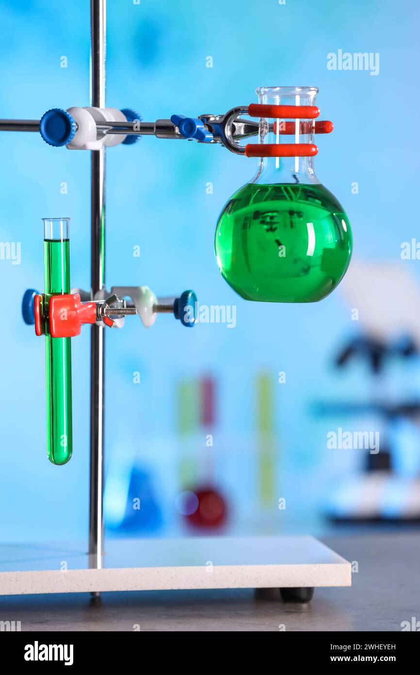 Laboratory glassware with green liquid on retort stand indoors Stock ...