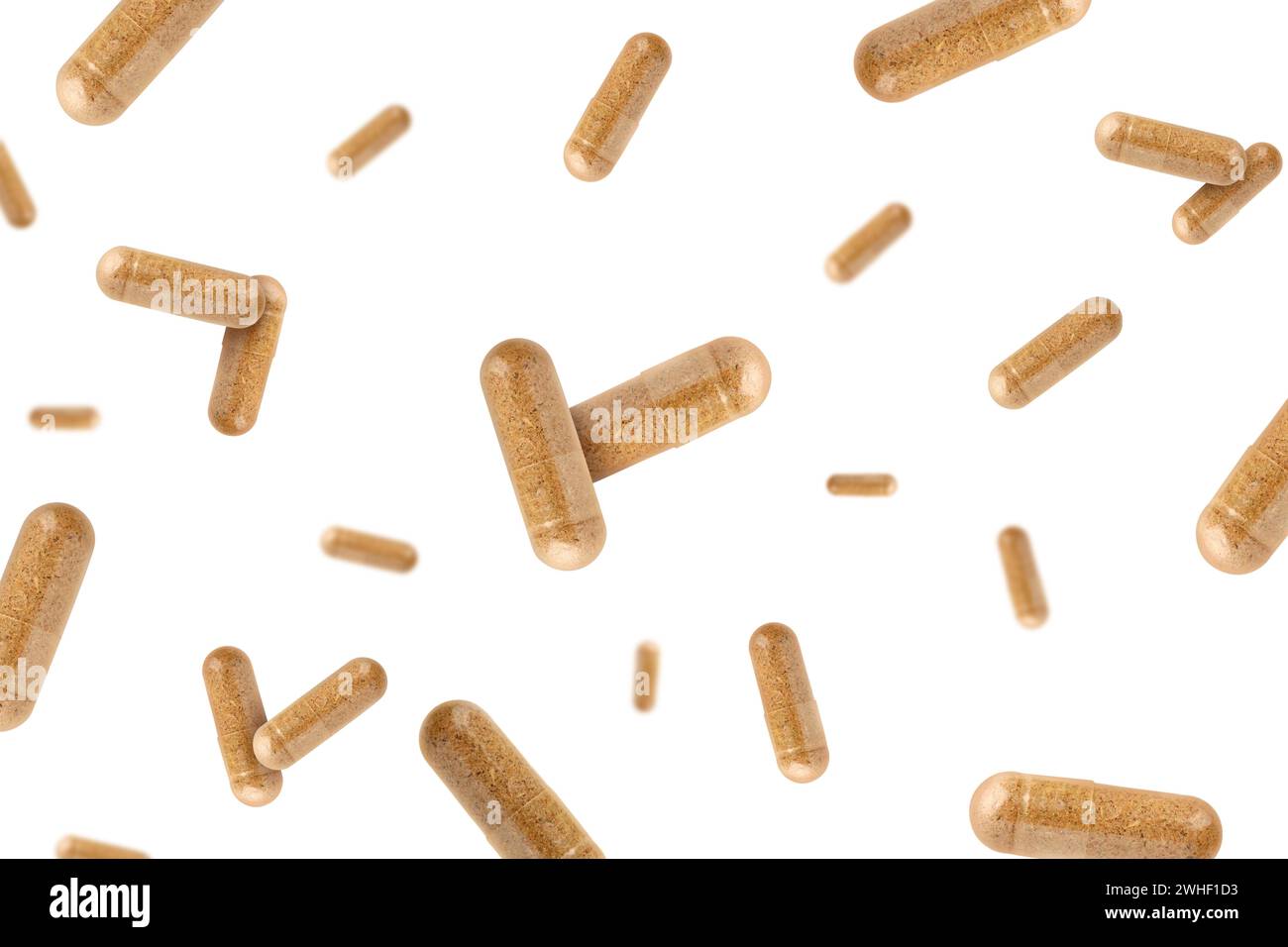 Vitamin. Many capsules falling on white background Stock Photo - Alamy