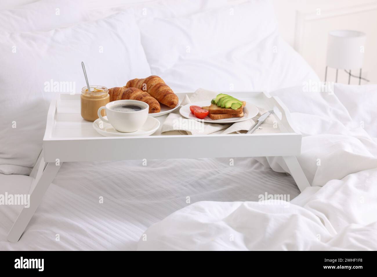 Good morning. Tray with tasty breakfast on bed Stock Photo - Alamy