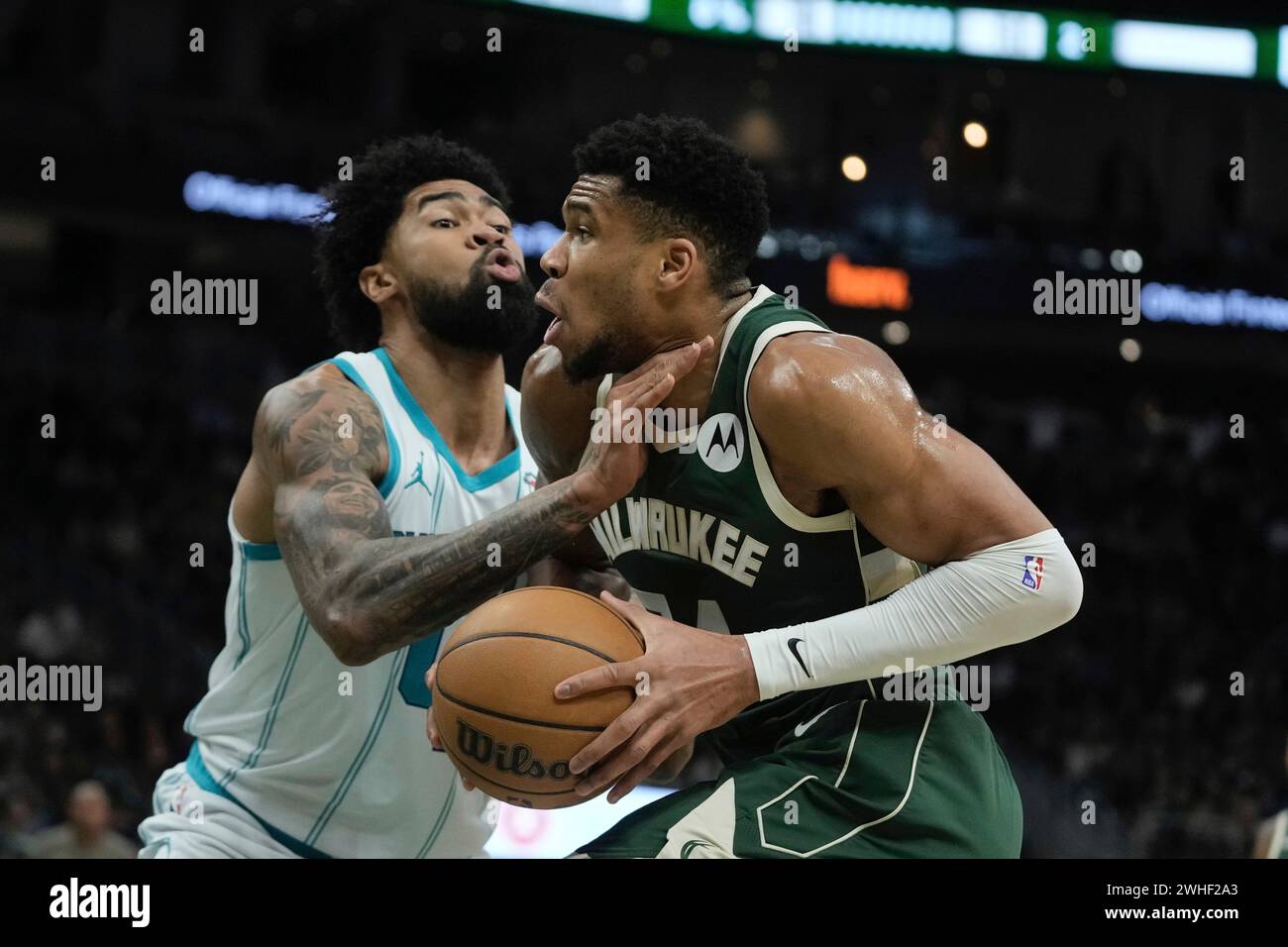 Milwaukee Bucks' Giannis Antetokounmpo is fouled by Charlotte Hornets ...