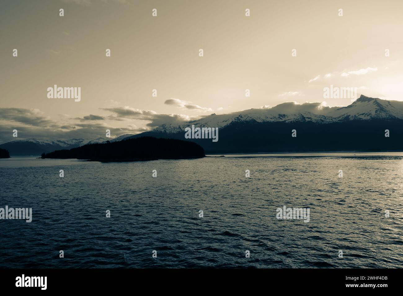 Early morning sun rising behind mountains aloing inside passage Stock ...