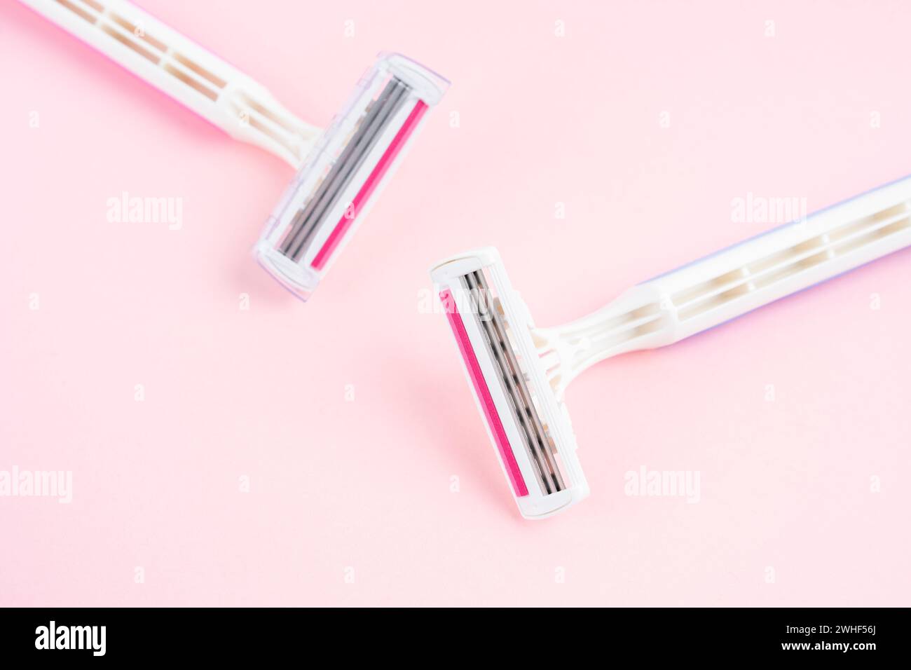 Two plastic, disposable razors on pink color background Stock Photo - Alamy