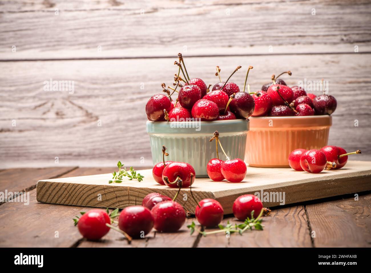 Red ripe cherries in ceramic bowls Stock Photo - Alamy