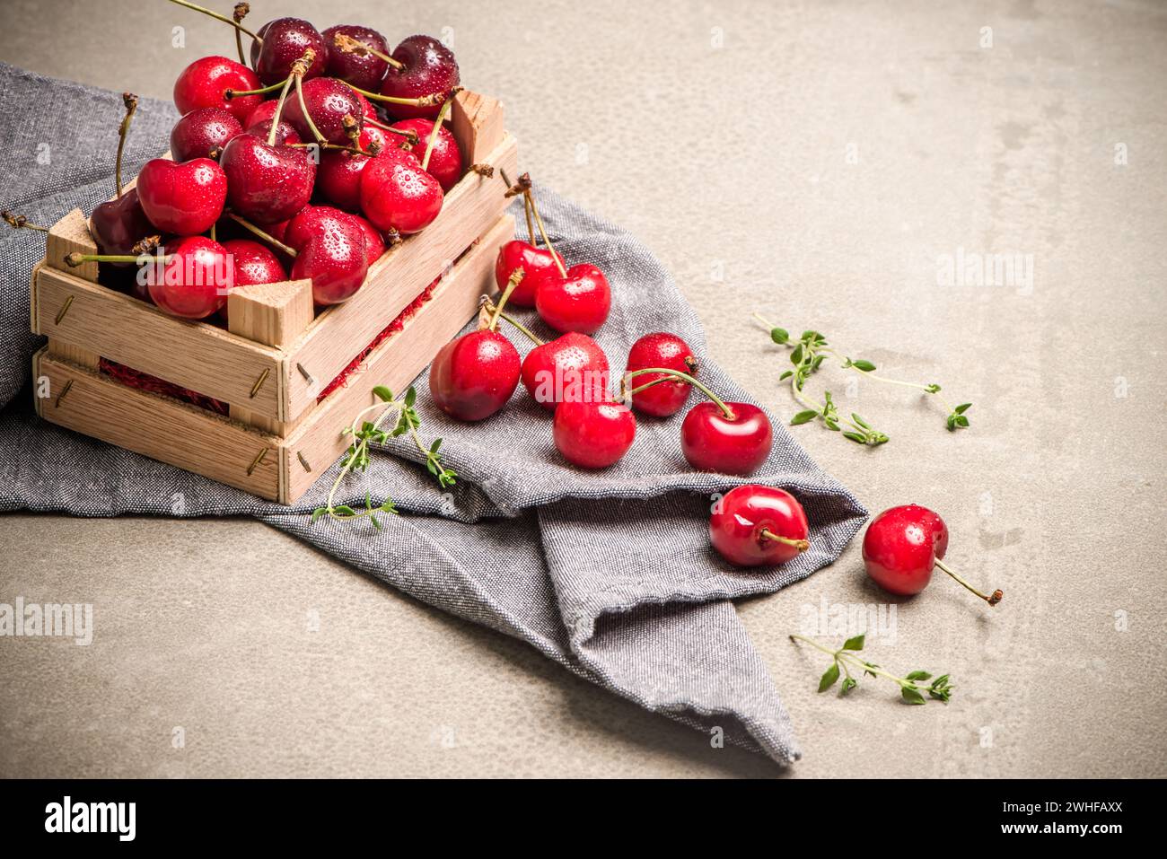 Red ripe cherries in small wooden box Stock Photo - Alamy