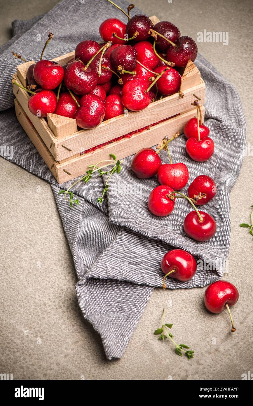 Red ripe cherries in small wooden box Stock Photo - Alamy