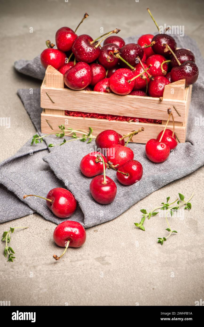 Red ripe cherries in small wooden box Stock Photo - Alamy