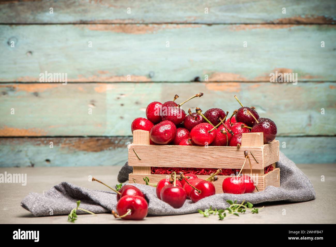 Red ripe cherries in small wooden box Stock Photo - Alamy
