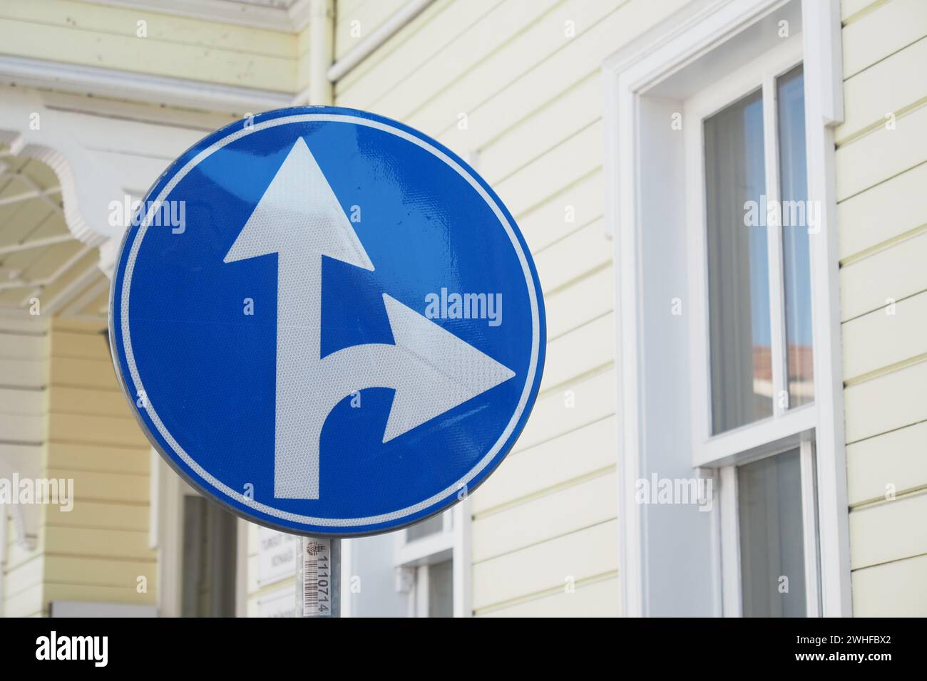 blue traffic sign with white arrows Stock Photo - Alamy