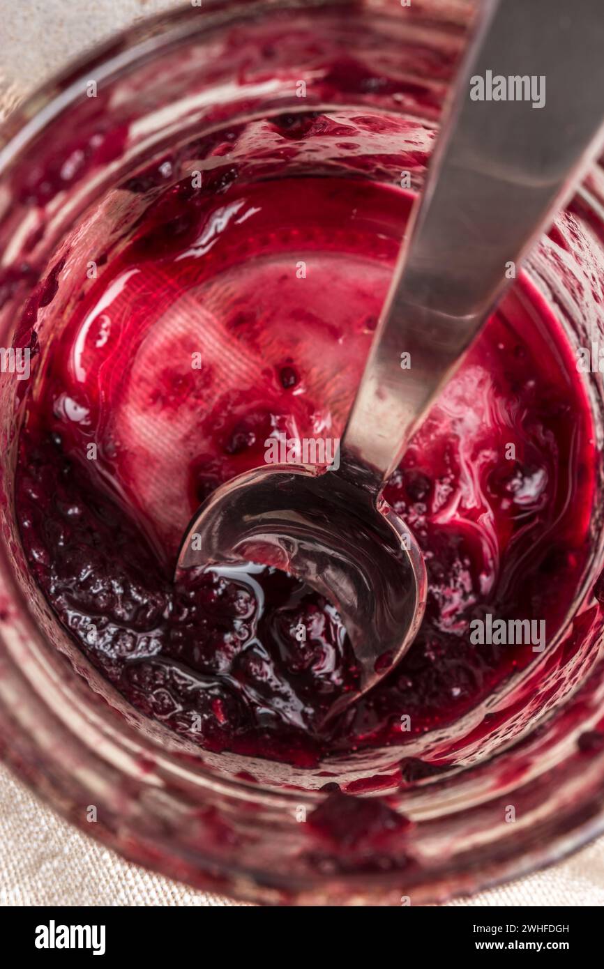 Glass jar with red fruits jam Stock Photo - Alamy