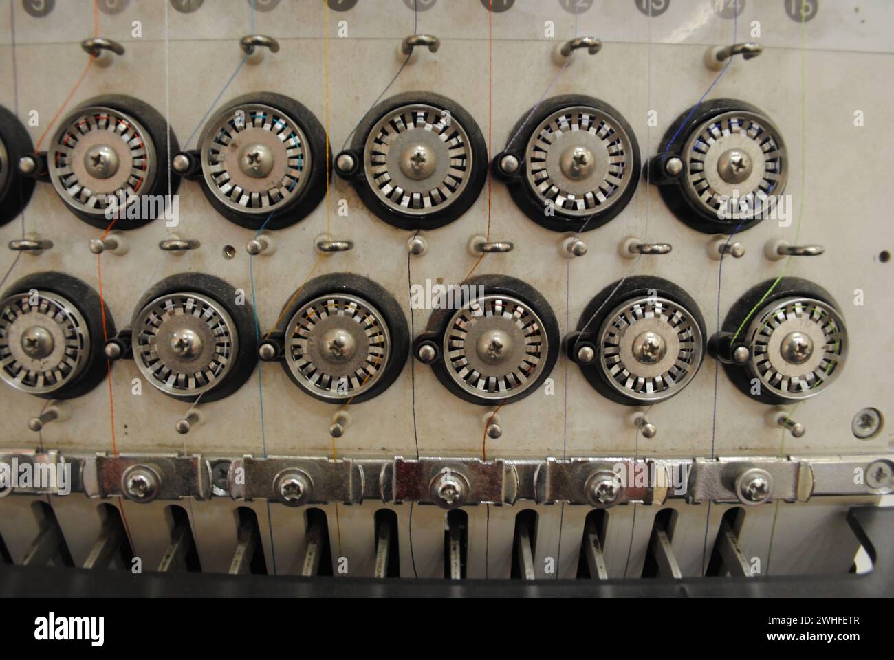 An old worn out embroidery machine. There are different colors of ...