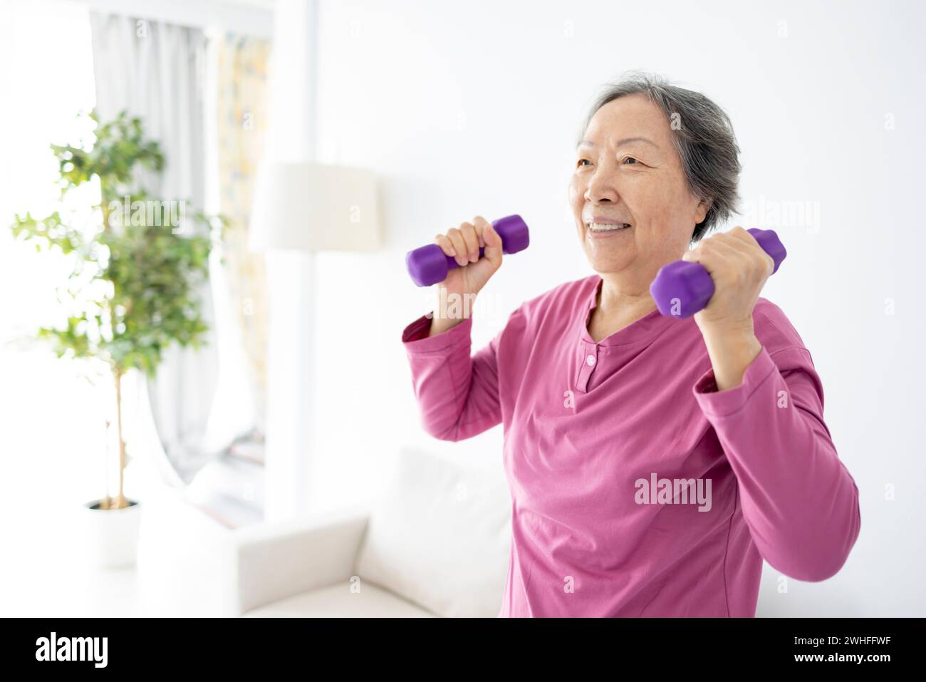 Senior woman exercises dumbbells hi-res stock photography and images ...