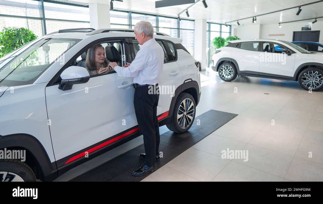 Mature woman car keys buying car hi-res stock photography and images ...