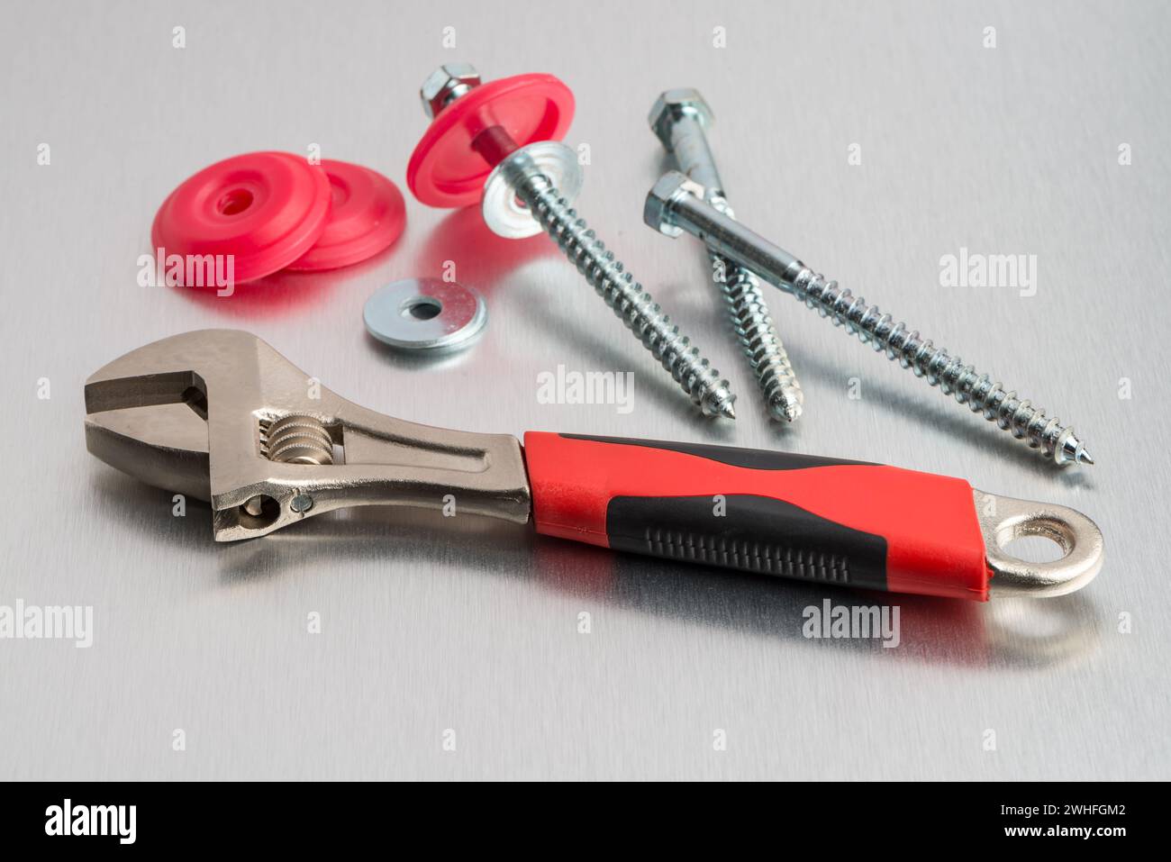 Spanner tool and screws Stock Photo - Alamy