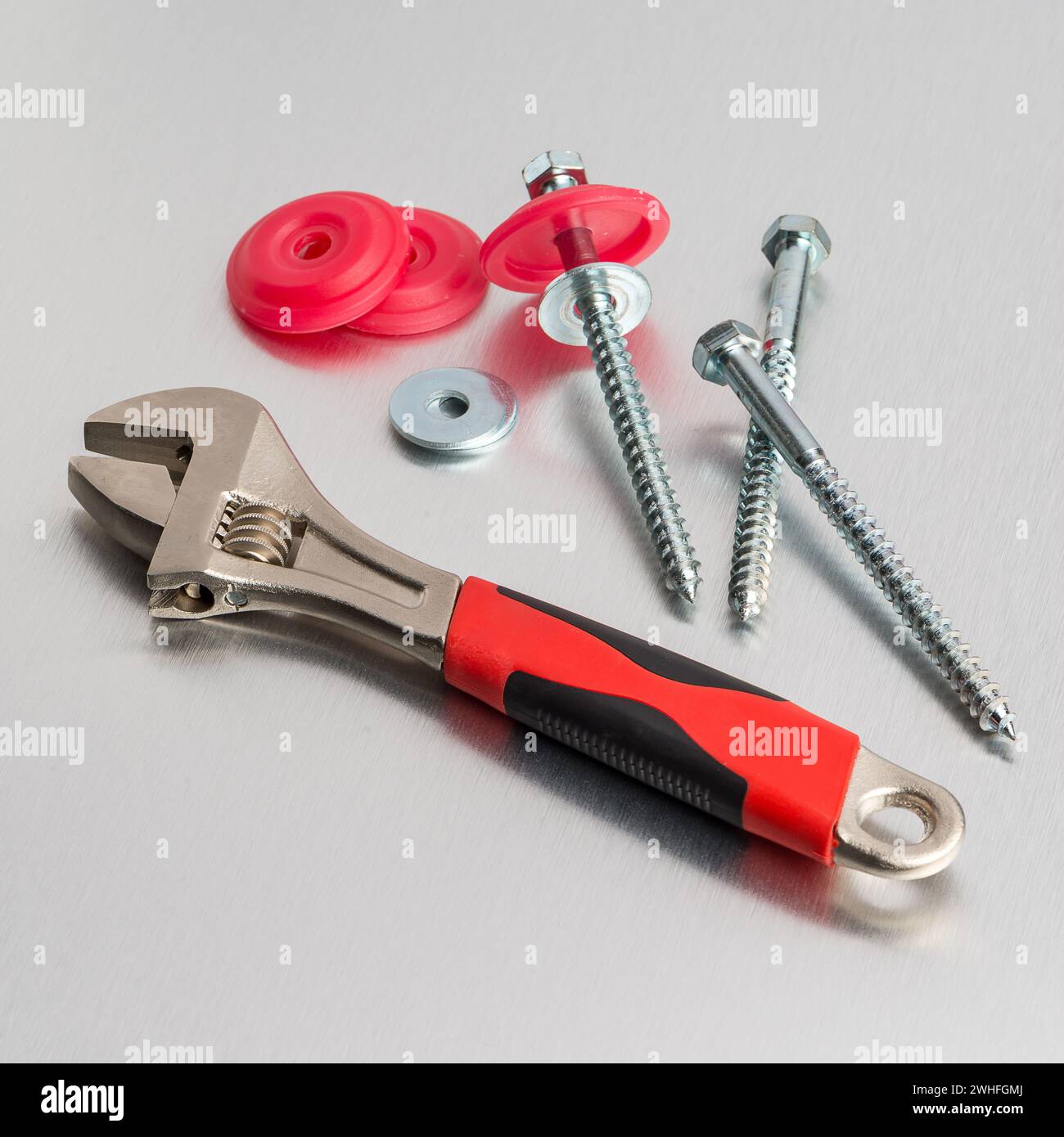 Spanner tool and screws Stock Photo - Alamy
