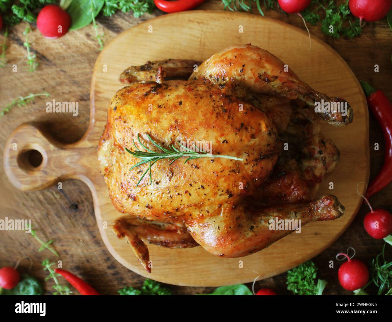 Whole roasted chicken on cutting board Stock Photo - Alamy